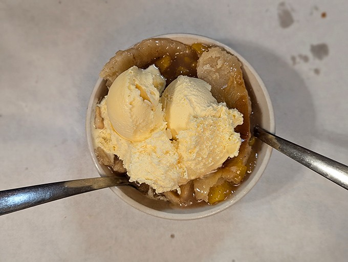 Grandmothers everywhere would approve of this peach cobbler. The ice cream melts into warm fruit like memories melting into time.
