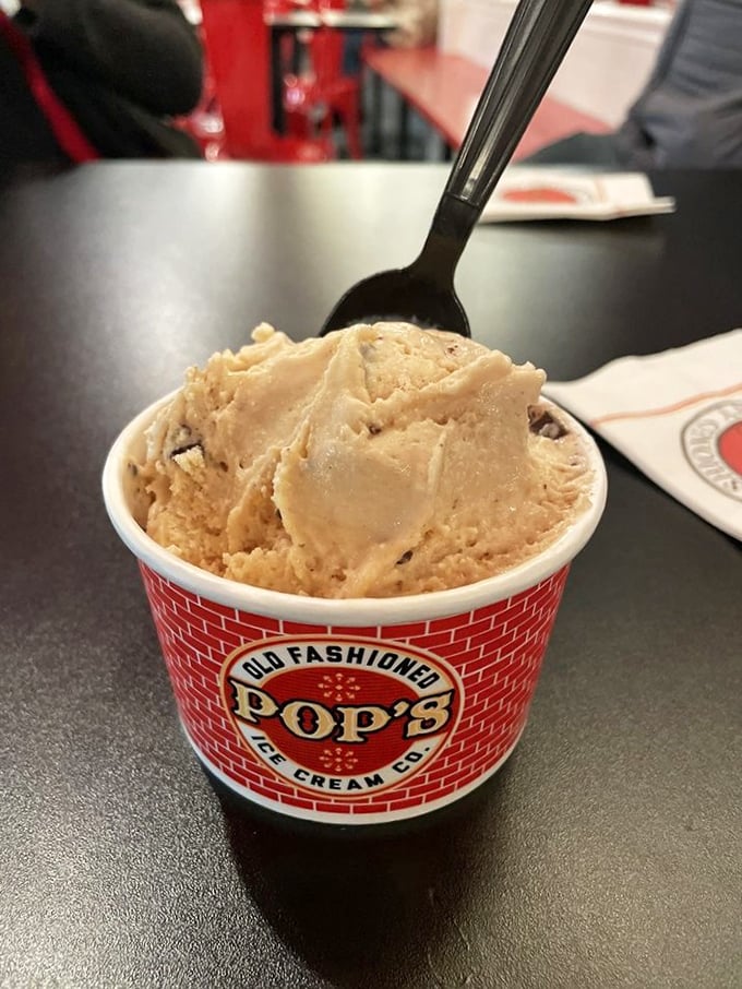 That butterscotch-hued scoop isn't just ice cream; it's edible sunshine with bits of what might be peanut butter morsels scattered like treasure.
