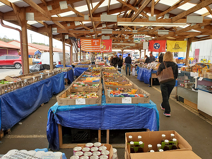 Under rustic wooden beams, shoppers browse tables laden with treasures. The Tennessee and American flags add a patriotic touch to this bargain hunter's paradise.