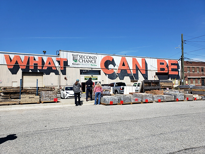 The exterior boldly proclaims "WHAT CAN BE" against a bright blue sky&mdash;a philosophical question and architectural salvage mission rolled into one.