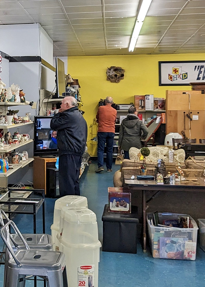 Shoppers examining electronics with the focused concentration of archaeologists. That vintage TV might just be someone's portal to nostalgic movie nights.