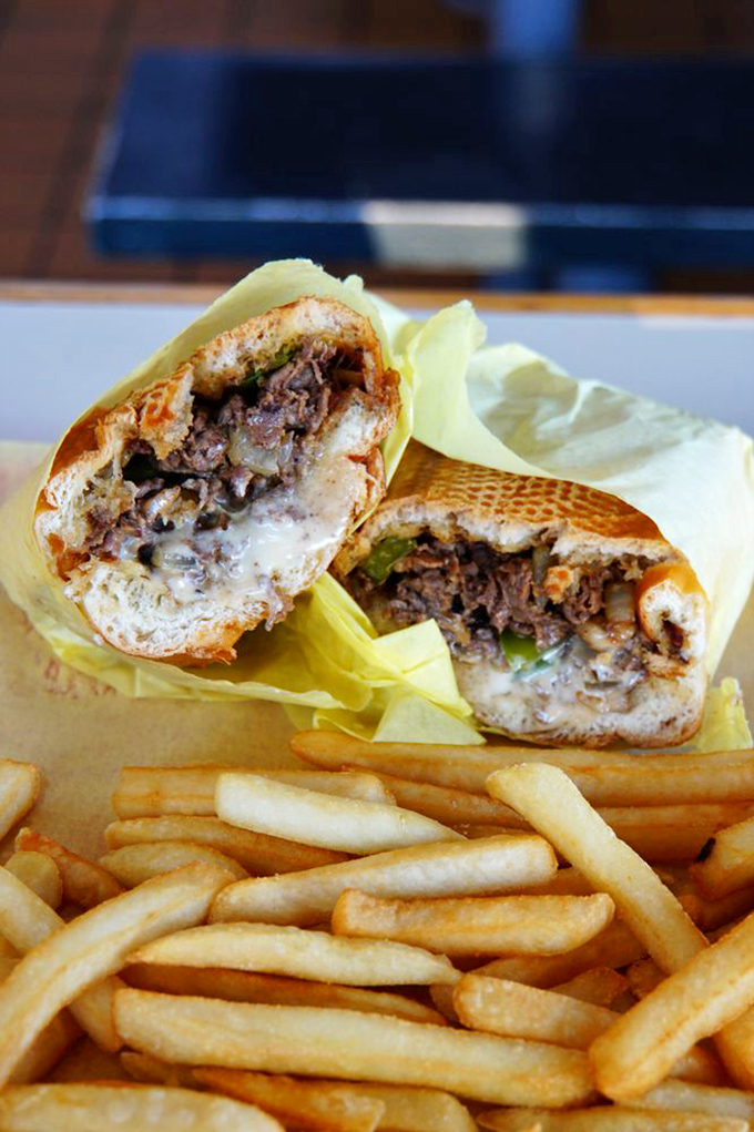 This isn't just a sandwich; it's architecture. Layers of thinly sliced beef and melted cheese create the Sistine Chapel of handheld meals.