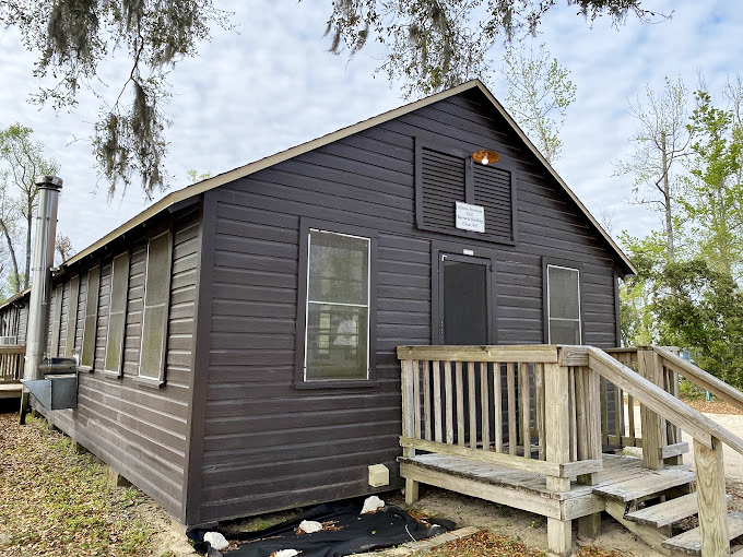 The cabin's front porch provides the perfect spot for morning coffee and contemplating why anyone would choose a hotel over this.