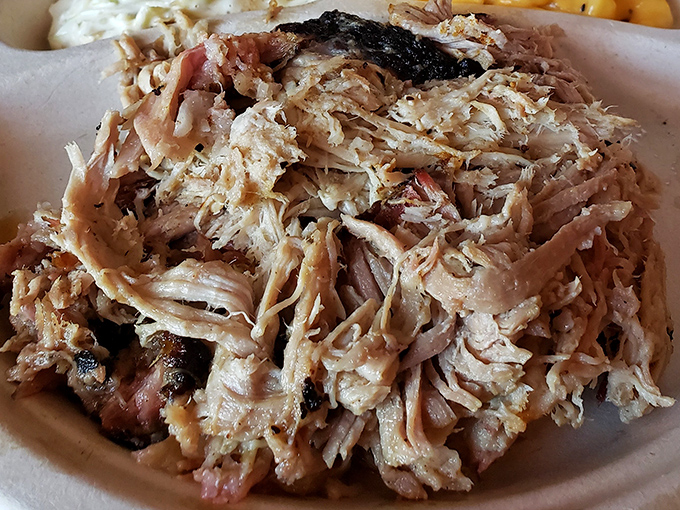 Pulled pork so tender it practically pulled itself. Each strand carries the perfect balance of smoke, spice, and porcine glory.