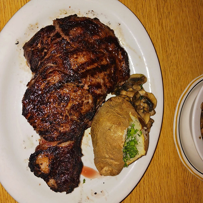 A steak with char marks so perfect they could make a geometry teacher weep. The baked potato sidekick isn't just along for the ride.