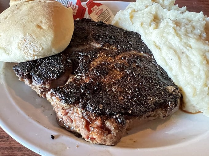 This ribeye doesn't need fancy garnishes—it commands respect all on its own, with mashed potatoes standing guard like loyal subjects.