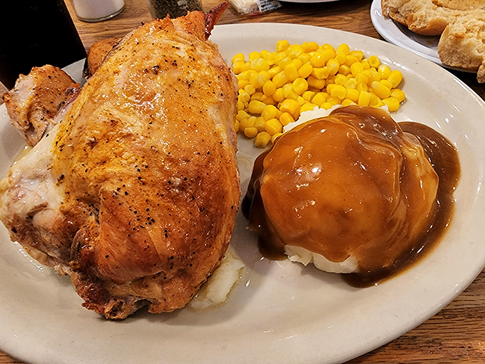 Rotisserie chicken so perfectly bronzed it could win a pageant, alongside mashed potatoes drowning happily in gravy's warm embrace.