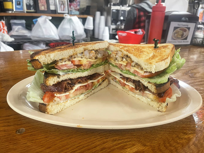 The club sandwich that launched a thousand road trips. Perfectly toasted bread holding together layers of lunchtime bliss.