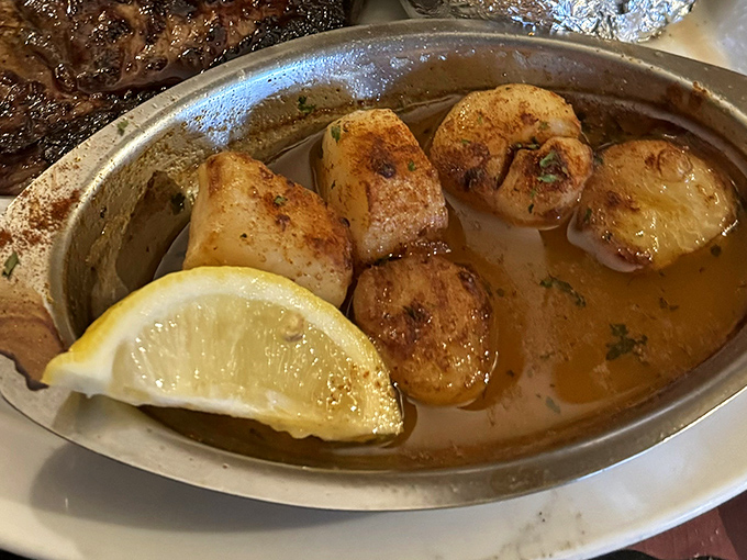 Scallops bathed in butter and kissed by flame&mdash;ocean candy that makes you wonder why you ever order anything else.