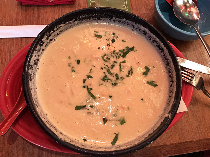 A bowl of creamy seafood soup that whispers, "Cancel your afternoon plans." Rich, comforting, and garnished with fresh herbs that brighten every spoonful.