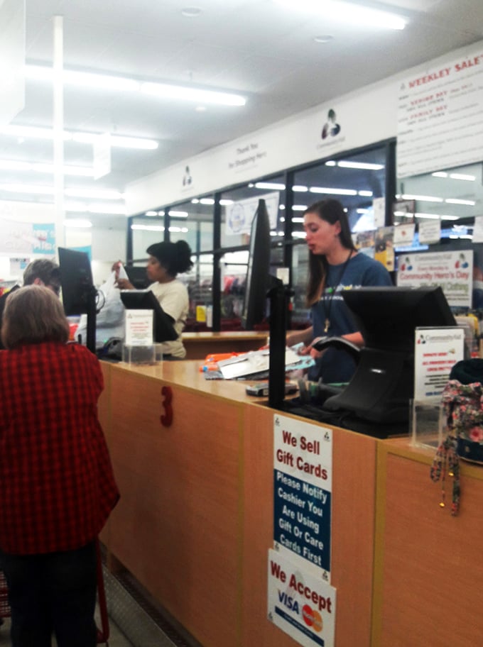 Where retail meets mission&mdash;the checkout area buzzes with purpose beyond just transactions. These folks are community heroes in blue shirts.