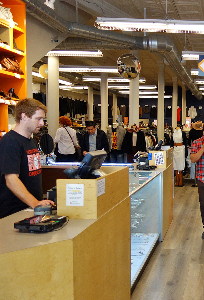The front counter, where fashion dreams meet reality. Staff members evaluate potential buys with the discerning eye of seasoned style scouts.