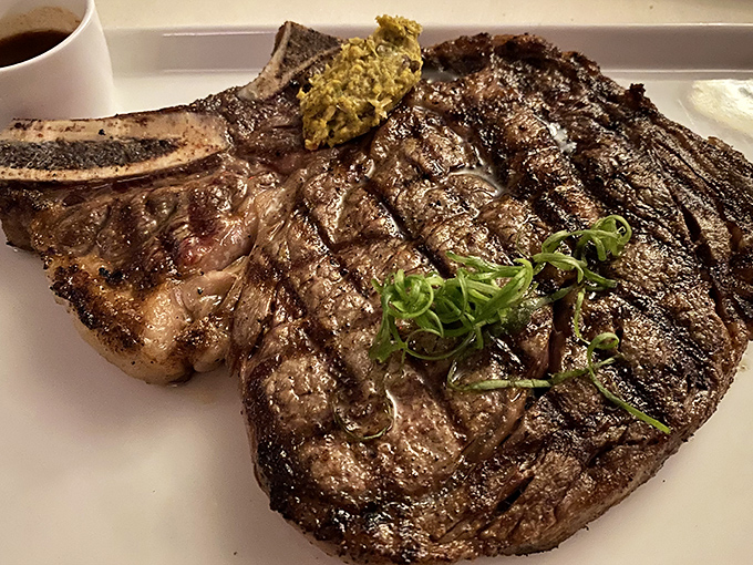 Grill marks so perfect they belong in a museum. The bone-in ribeye isn't just dinner; it's performance art you can eat.