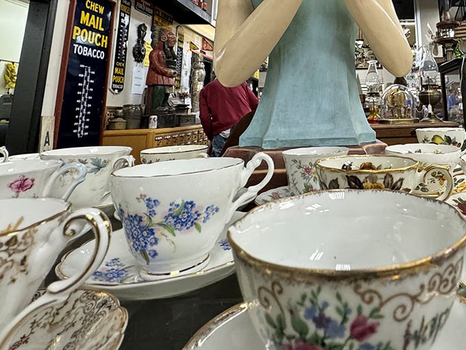 Delicate teacups waiting for their next conversation. Each floral pattern and gold rim has witnessed decades of gossip and comfort.