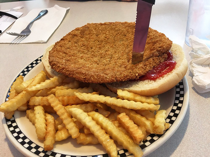 Indiana's state sandwich in its natural habitat. The breaded tenderloin extending beyond its bun borders is the Hoosier equivalent of "you're getting your money's worth."