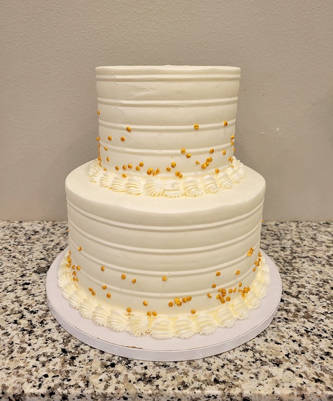Wedding cake or everyday indulgence? With its elegant gold accents and pristine frosting, this two-tiered beauty elevates any occasion from "Tuesday" to "memorable."