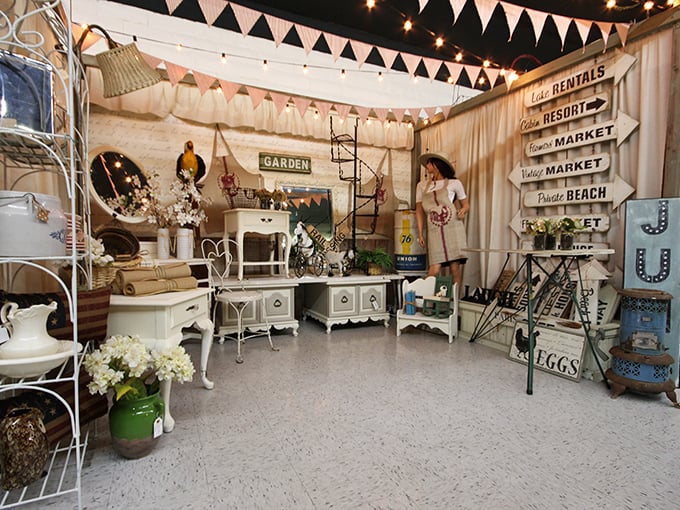 Bunting, directional signs, and shabby-chic furniture create a whimsical farmhouse fantasy. This booth feels like the Pinterest board of your dreams came to life.