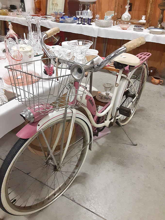 This pink vintage bicycle isn't just transportation &ndash; it's someone's childhood freedom, first date, or paper route, now artfully repurposed as d&eacute;cor.