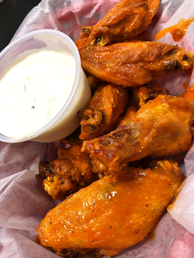 Buffalo wings glowing with tangy promise. These aren't just appetizers &ndash; they're the reason napkins were invented.