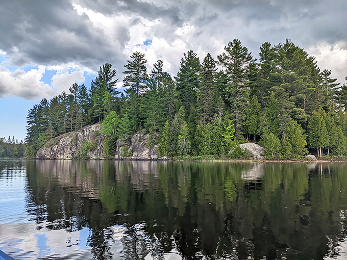Craig Lake's mirror-like waters perfectly reflect the surrounding wilderness, doubling the beauty in Michigan's most remote state park.