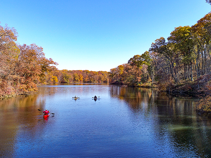 Rustic charm! Siloam Springs' wooden shelter invites picnickers to enjoy lake views while protected from surprise summer showers.