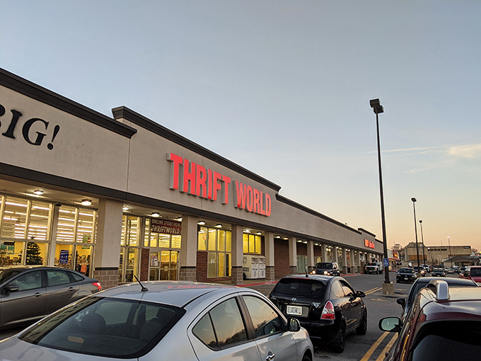 Thrift World announces itself with no-nonsense confidence. That illuminated storefront glows with possibility at dusk.
