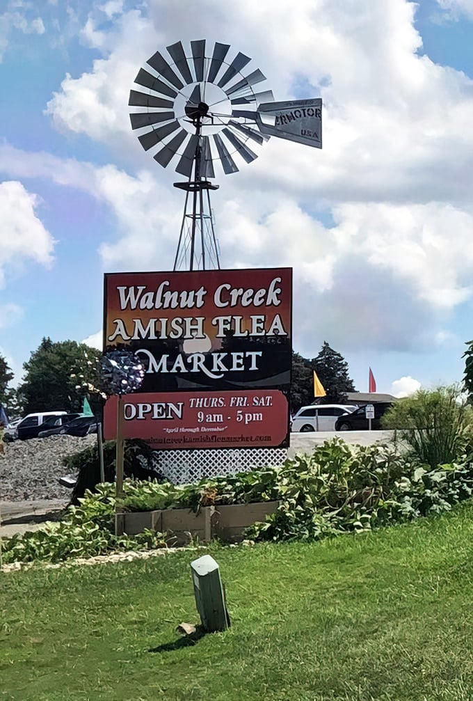 Walnut Creek's windmill sign stands tall against blue skies&mdash;a beacon for those seeking authentic Amish craftsmanship.
