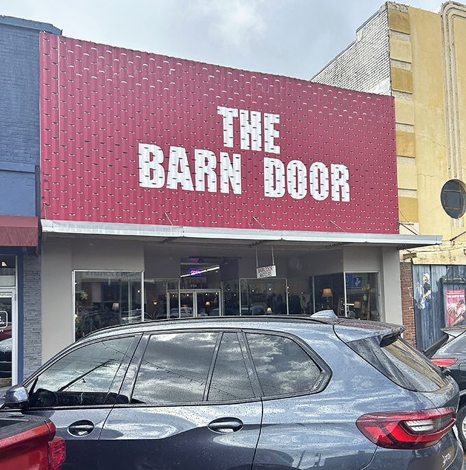 Like a beacon of nostalgia, The Barn Door's distinctive storefront promises vintage treasures behind its welcoming entrance.