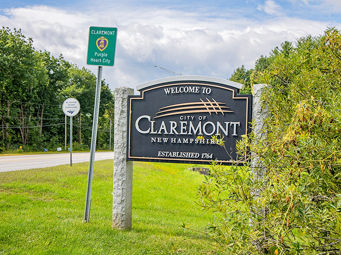 Claremont's "Purple Heart City" sign stands proudly alongside its welcome marker. This Connecticut River town honors its veterans with genuine New England sincerity.