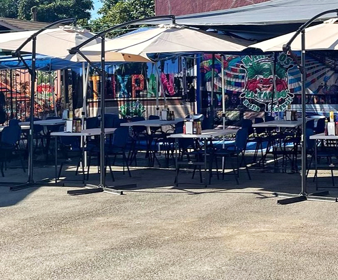 Colorful umbrellas shade tables where seafood dreams come true, one giant shrimp cocktail at a time.