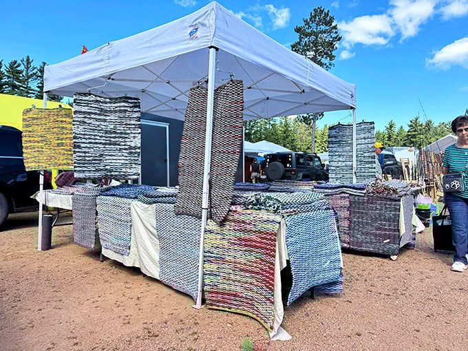 Handwoven rugs hang like colorful flags, each pattern telling stories that shoppers can take home for a song.