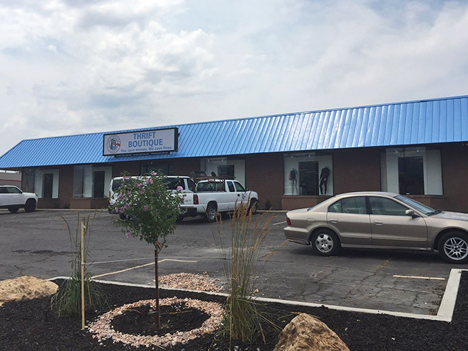 Blue awnings and brick facades give this thrift boutique the look of a neighborhood friend rather than just another store.