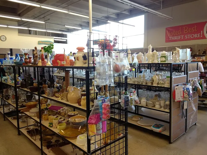 The carpet may be plain, but the treasures inside Deseret Industries are anything but. A sea of circular racks awaits!