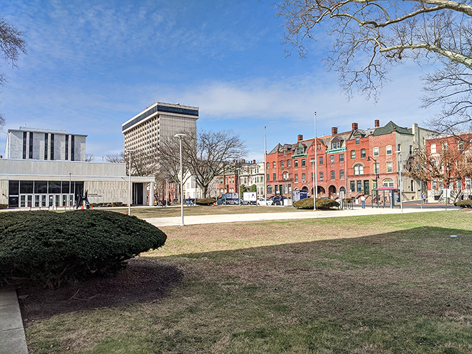 Historic buildings frame a modern civic center - where yesterday and today shake hands in the park.