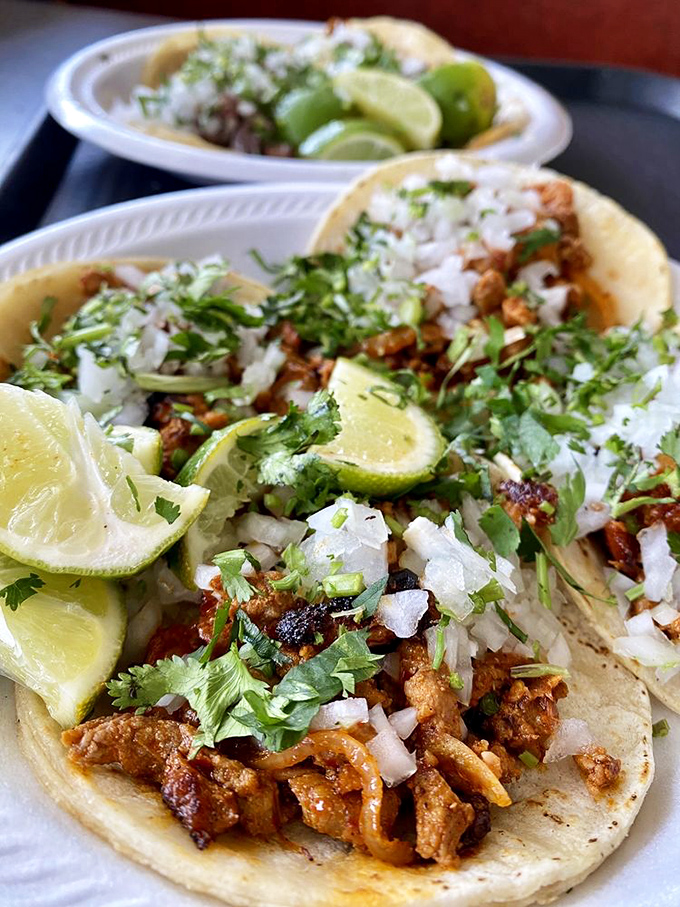 Tacos dressed in their Sunday best &ndash; cilantro, onion, and lime creating the holy trinity of taco perfection. One bite and you'll understand why people drive for hours.