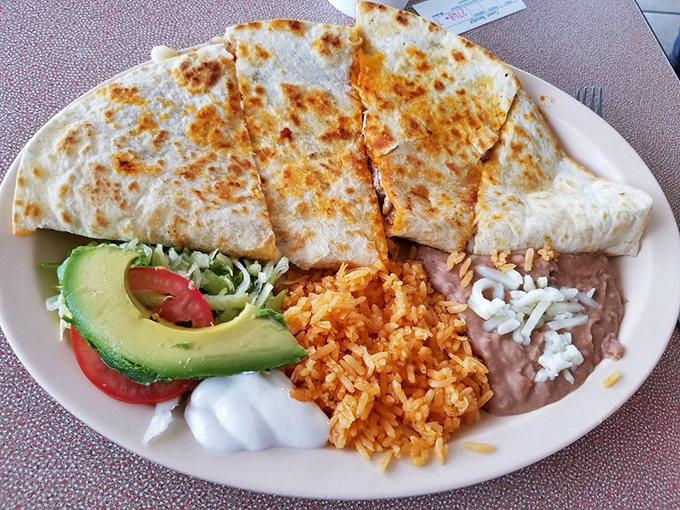 Quesadillas done right&mdash;golden, crispy exterior giving way to melty cheese and savory fillings. That fresh avocado slice is the perfect cool counterpoint.