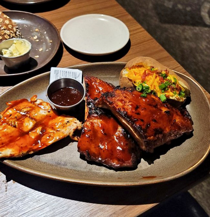 Glistening ribs and chicken sharing a plate like old friends, their sauce-lacquered surfaces reflecting hopes, dreams, and the promise of flavor-induced euphoria.