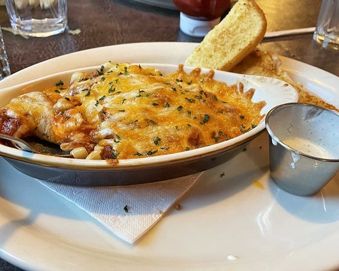 Cheese pulling double duty as both blanket and flavor enhancer on this baked spaghetti&mdash;carb heaven with a golden crown.