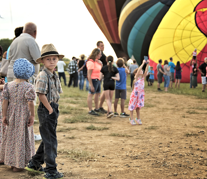 Where else but Amish Country can you witness the beautiful contradiction of traditional clothing against the technicolor backdrop of modern hot air balloons?