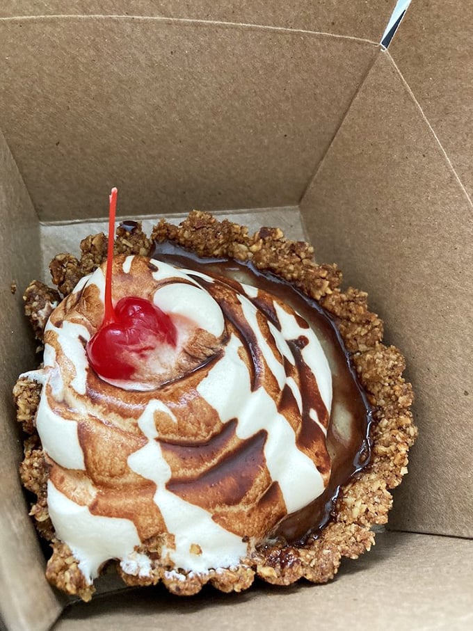 This banana split tart in its humble cardboard container is like finding a Broadway star performing in your local coffee shop&mdash;unexpected brilliance in casual packaging.