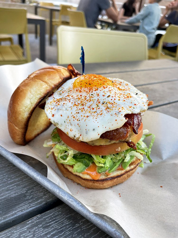 The Battle Royale burger doesn't just sit on the plate&mdash;it commands it. That perfectly fried egg is the crown on a monarch of meat.