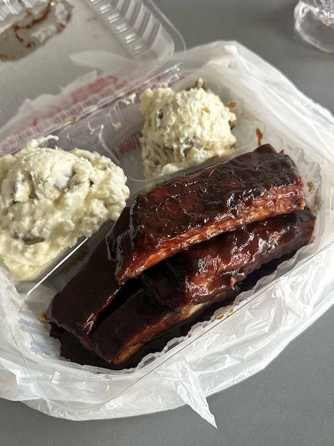 Ribs glistening with sauce alongside potato salad that's achieved the perfect consistency. This tray represents everything right with American comfort food.