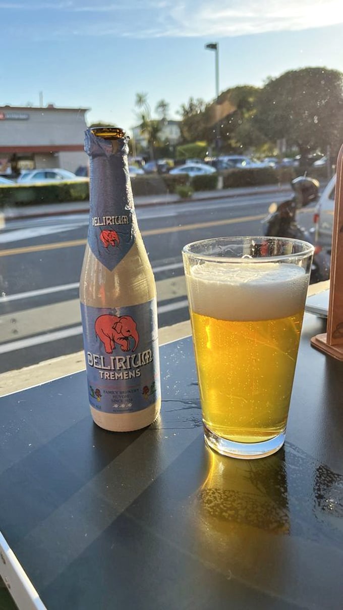 Nothing complements a feast like a cold Delirium Tremens, its golden effervescence catching the late afternoon light like liquid sunshine.
