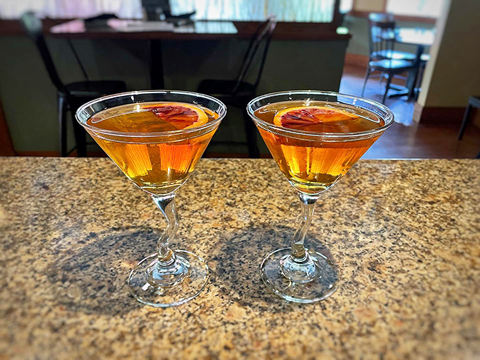 Two blood orange Manhattans waiting to be enjoyed&mdash;because sometimes the best appetizer is actually a cocktail. That amber color promises warmth before the first sip.