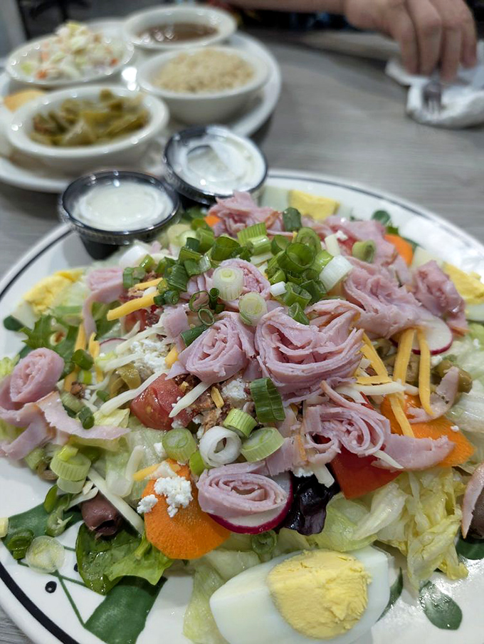 A salad that doesn't apologize for being hearty. Fresh vegetables playing host to a party of ham, cheese, and egg&mdash;all dressed for success.