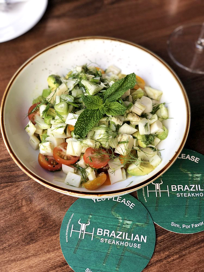 Not just a token vegetable offering. This vibrant chopped salad with fresh herbs and cherry tomatoes proves Brazilians understand balance in all things.