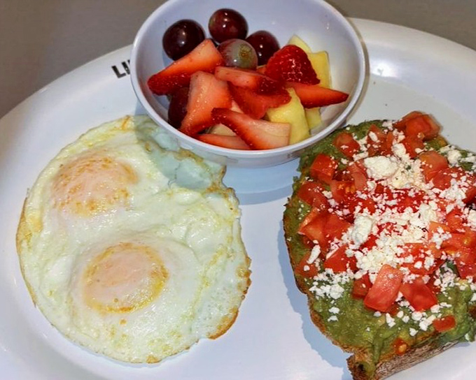 The avocado toast and eggs platter—where California health food meets Midwest portions, proving virtuous eating doesn't require sacrifice.