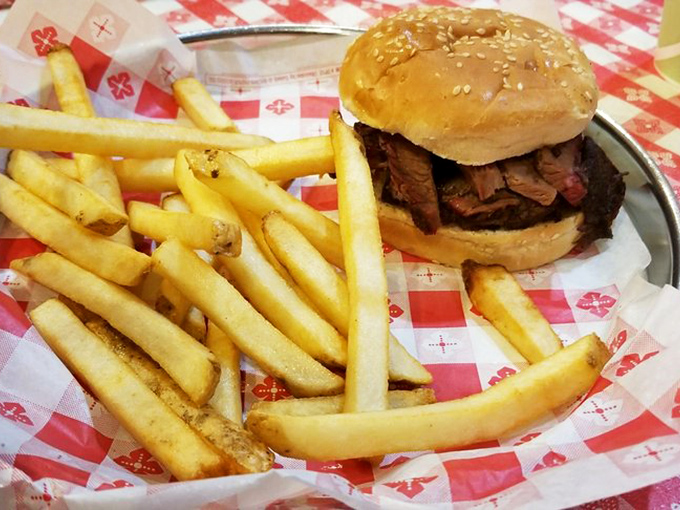 A brisket sandwich that could convert vegetarians and crispy fries that deserve their own fan club. Simple perfection on a metal tray.