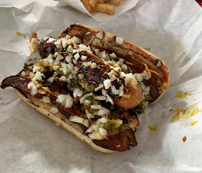 Hot dog royalty: This isn't your ballpark frank&mdash;it's a quarter-pound beauty crowned with grilled onions and enough toppings to require a strategy.