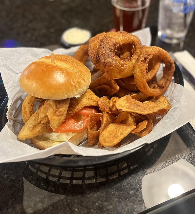 The burger's impressive height is matched only by its flavor, while those homemade chips provide the perfect crunchy counterpoint.